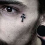 Cross Tattoo Under The Eye Meaning (6 Key Insights)